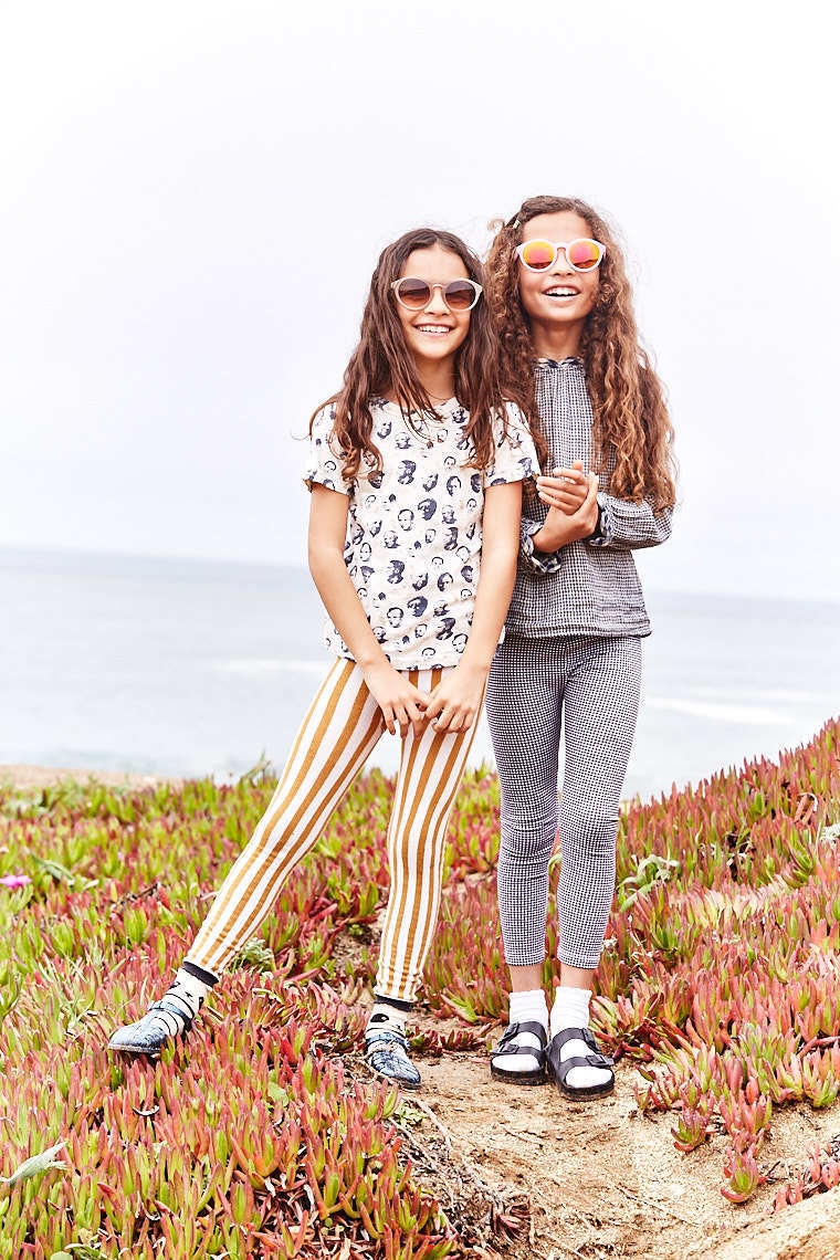 Two young girls pose in sand dunes wearing funky sunglasses for Kids ...